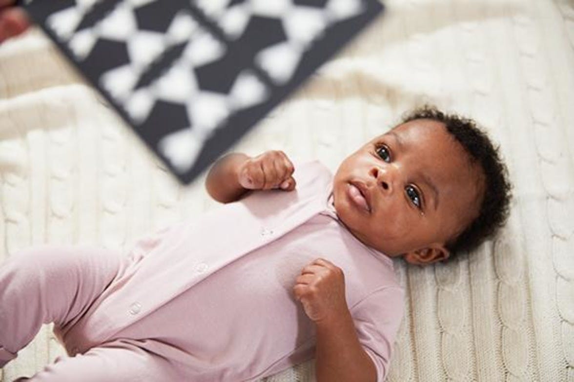 When do babies learn to reach and grasp objects? | Lovevery